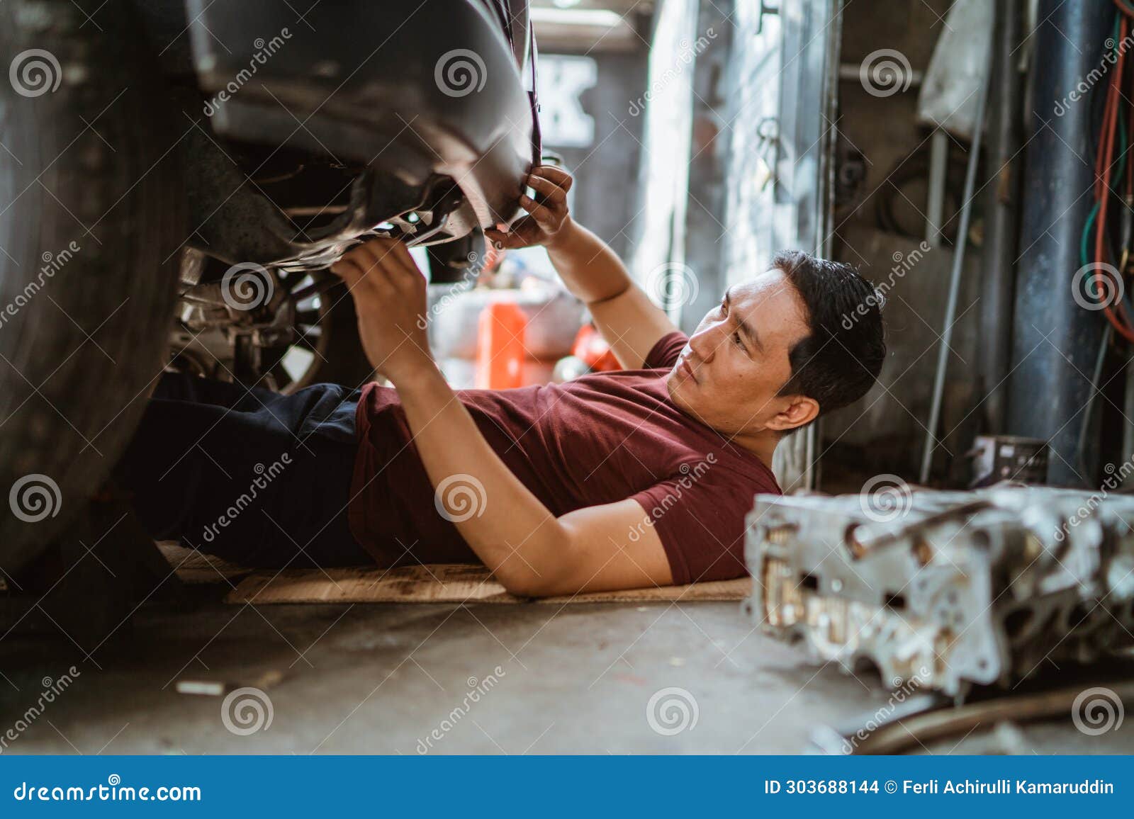 Mechanic Checks the Damage on the Lower Front of the Car Stock Photo ...