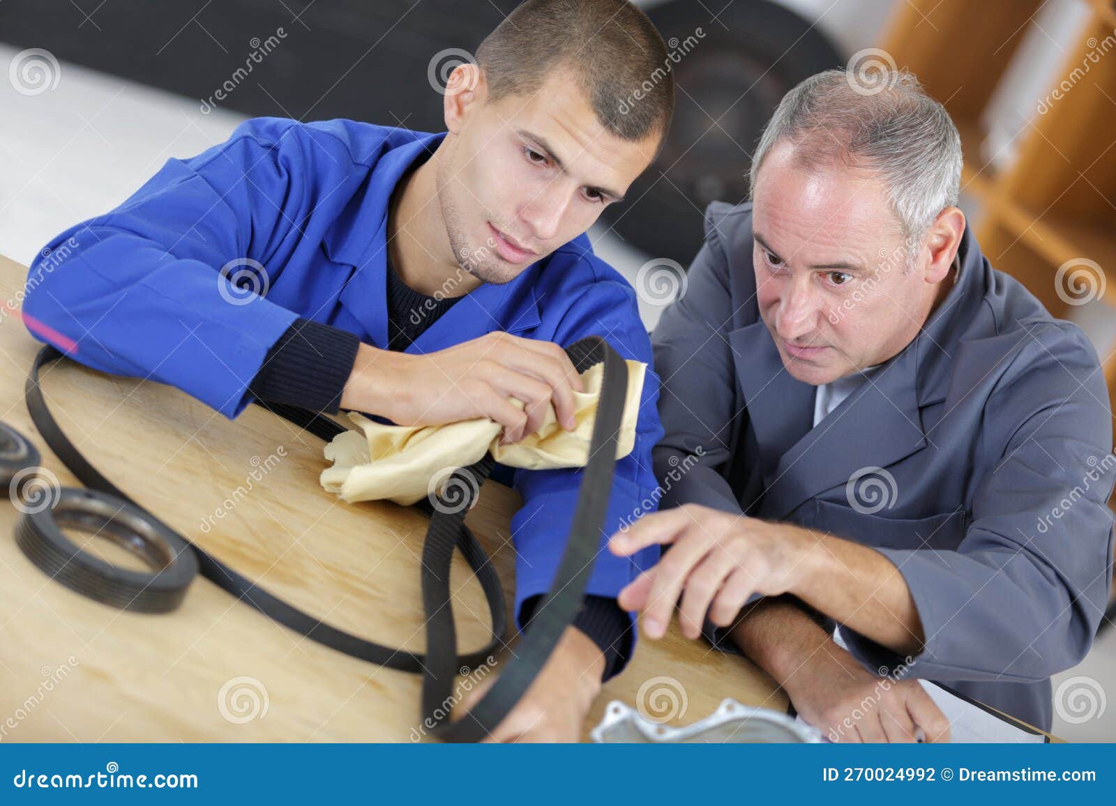 Mechanic Cleaning Timing Belt in Warehouse Garage Stock Photo - Image ...