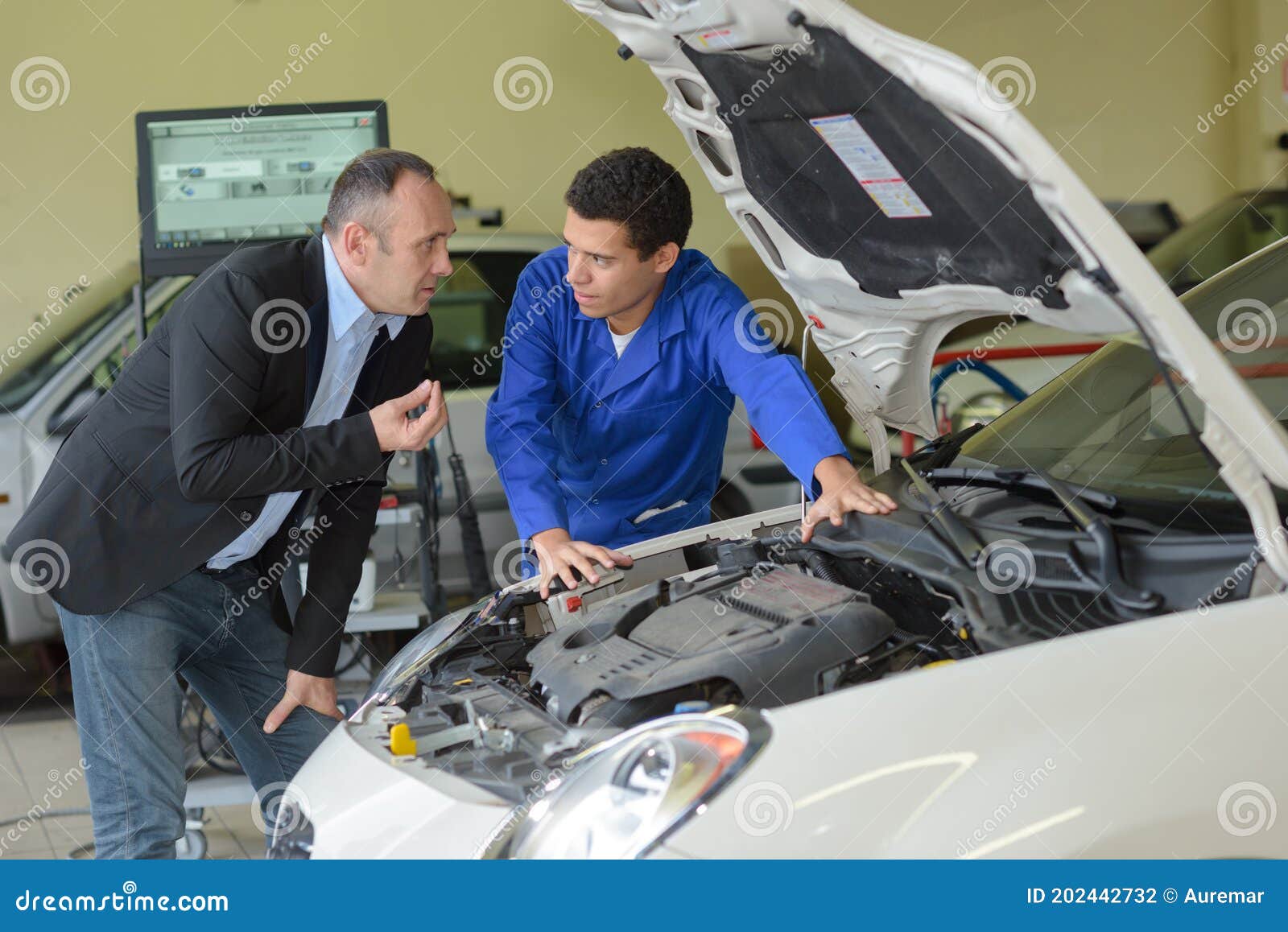 Mechanic with Client at Auto Service Stock Photo - Image of client ...