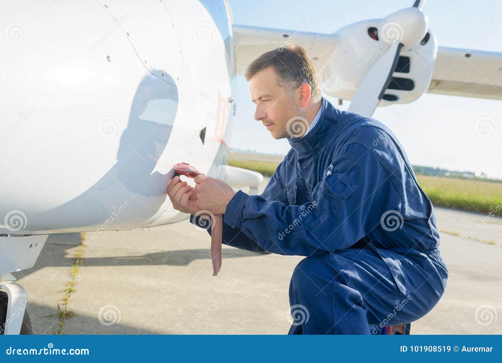 Mechanic Crouched Working on Side Aircraft Stock Image - Image of ...