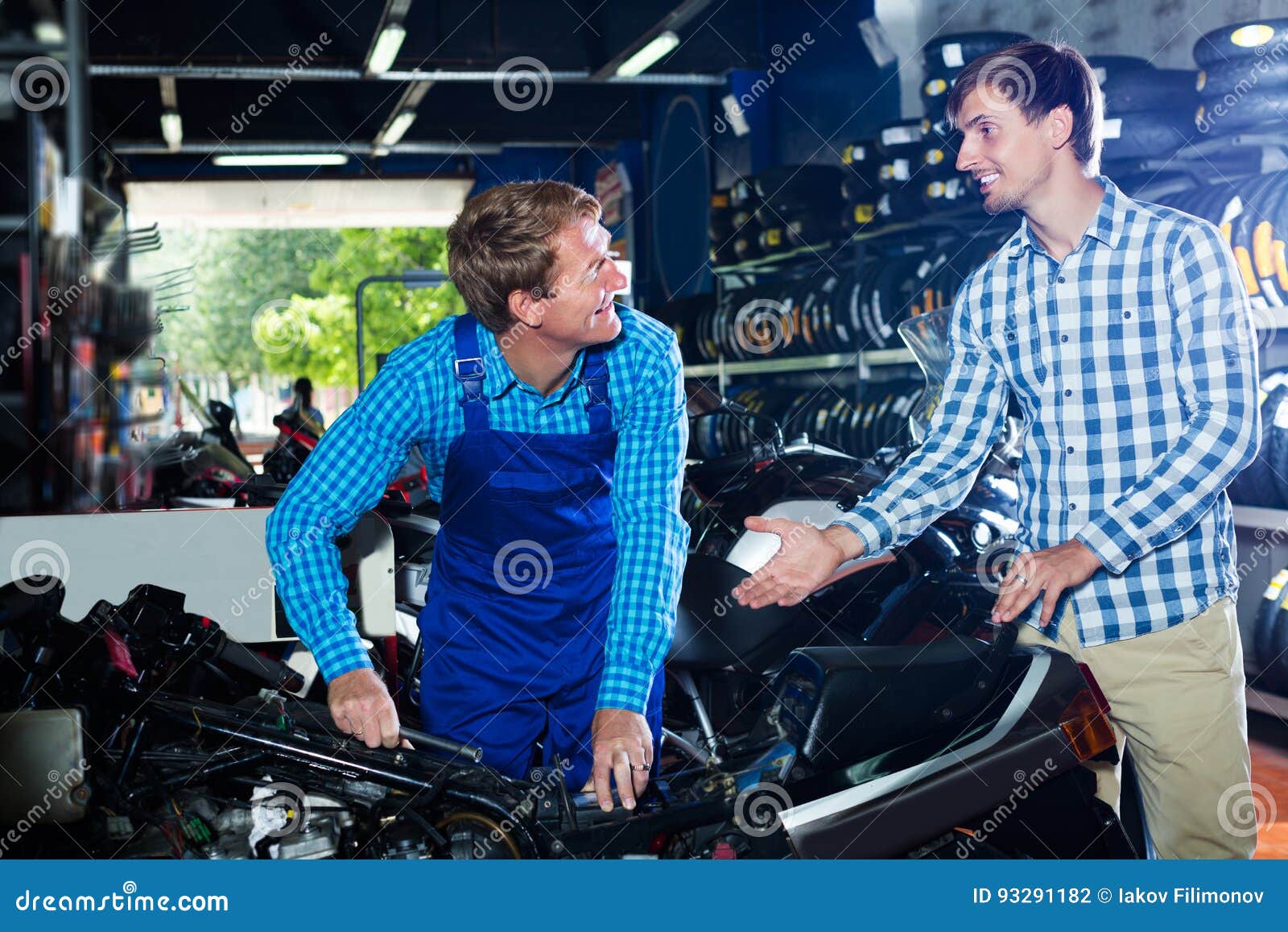 Mechanic and Customer Talking about Motorbike Stock Photo - Image of ...