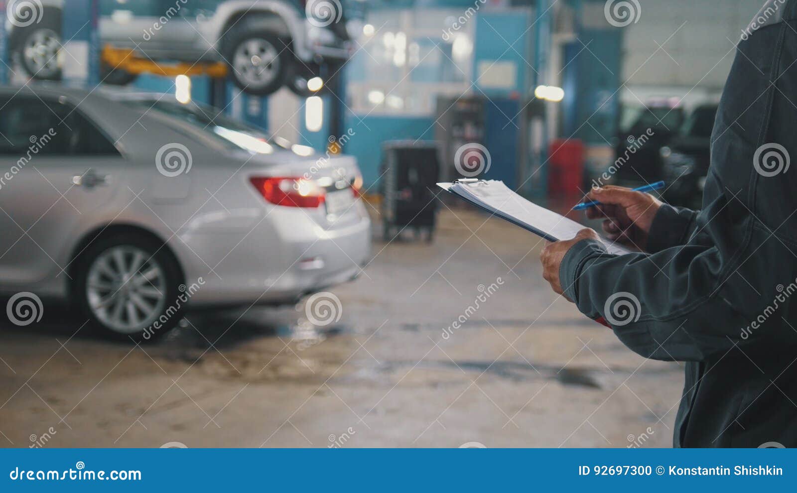 Mechanic Doing Checking of a Car in a Garage Workshop Stock Photo ...