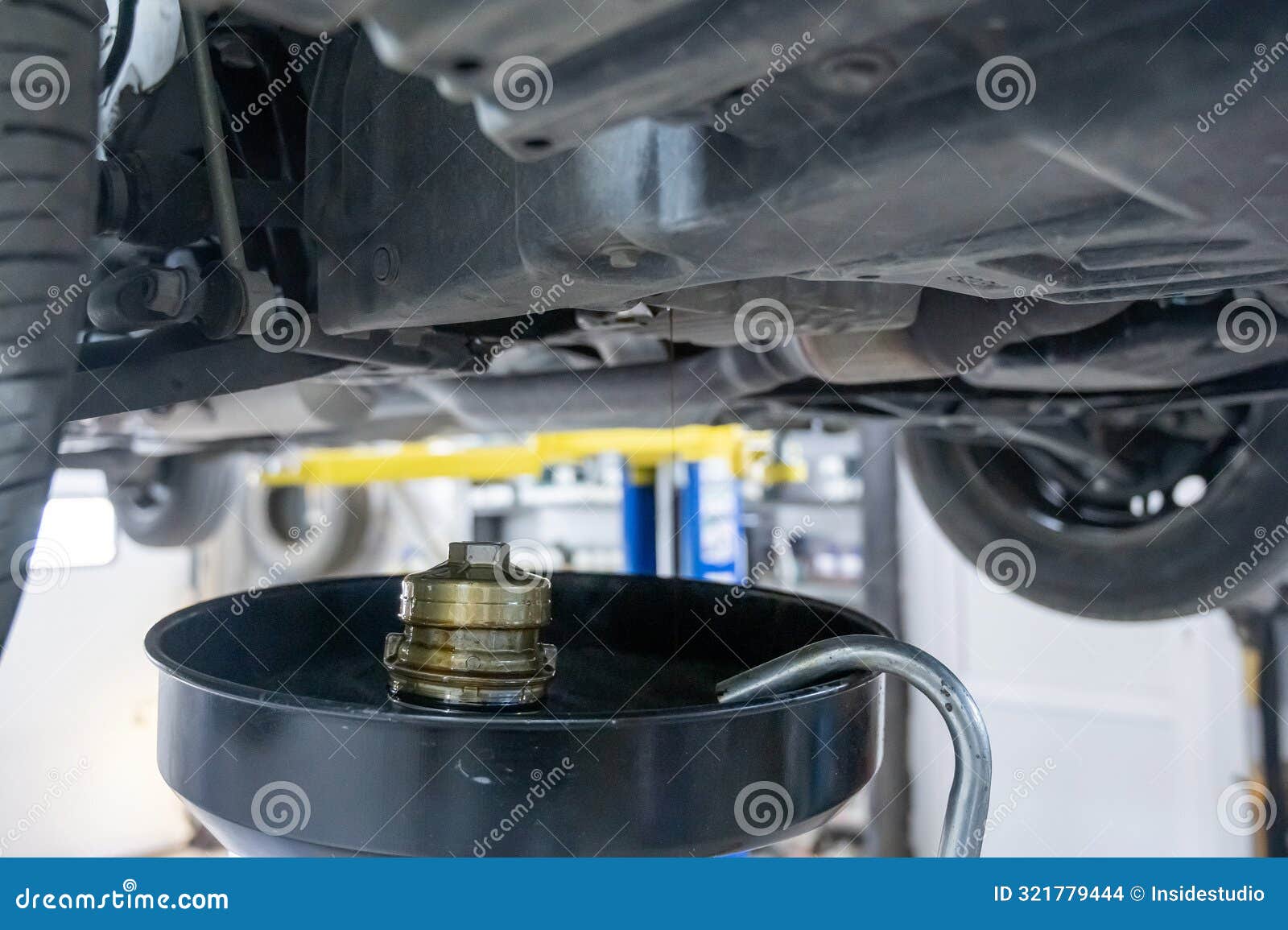 A Mechanic Drains a Car S Used Engine Oil. Stock Photo - Image of ...