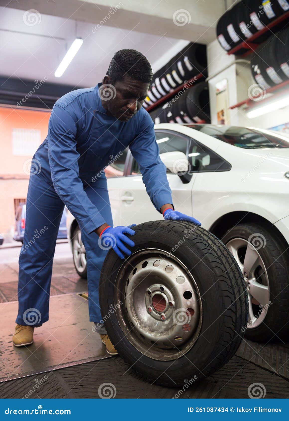 Mechanic Engaged in Replacement of Tyre on Car Wheel in Workshop Stock ...