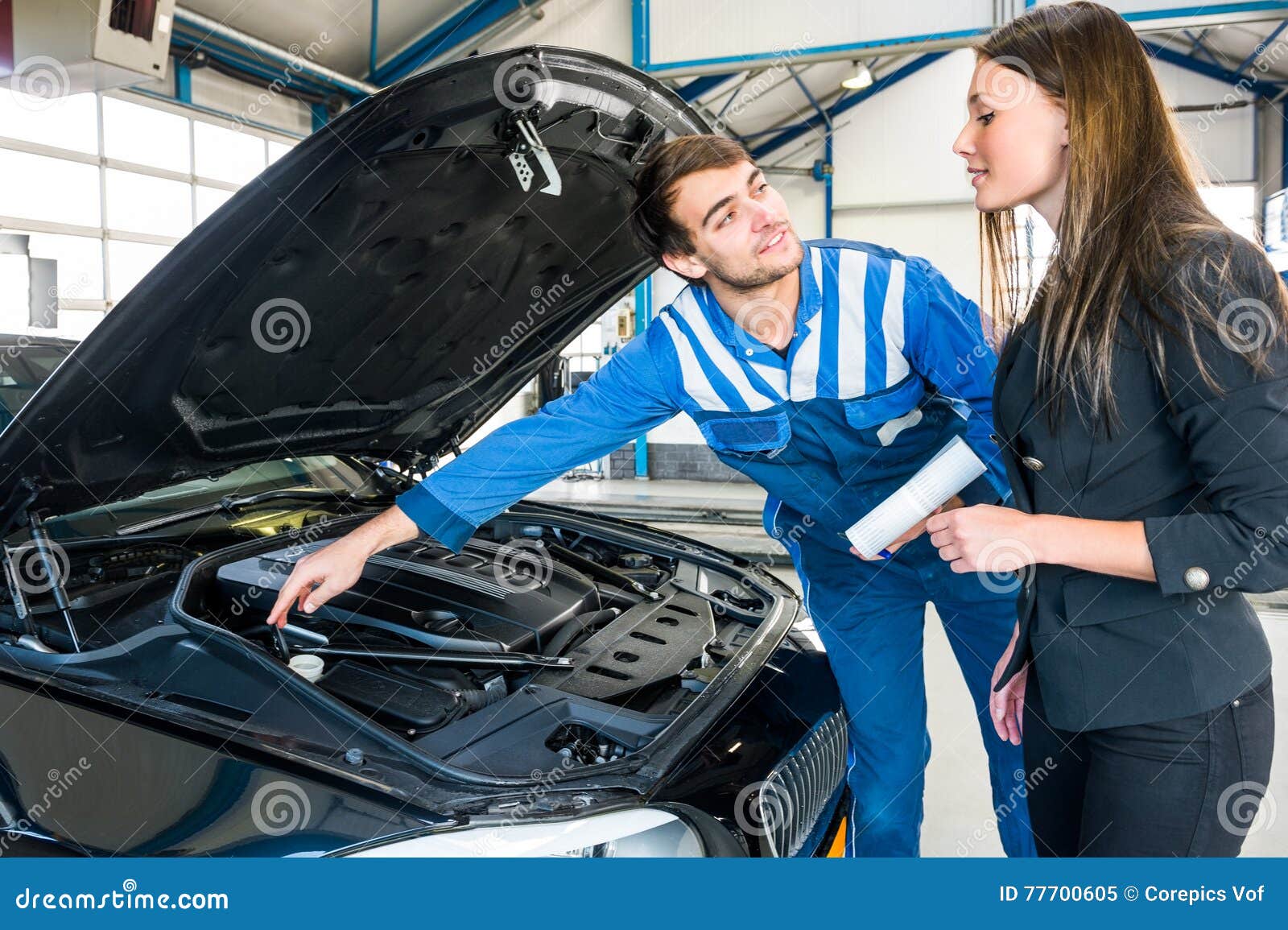 Mechanic Explaining Problems To Customer in Garage Stock Image - Image ...