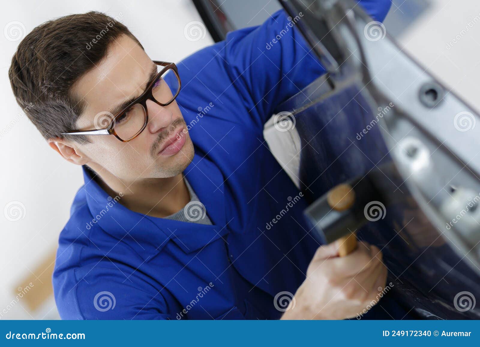 Mechanic fitting car door stock photo. Image of production - 249172340