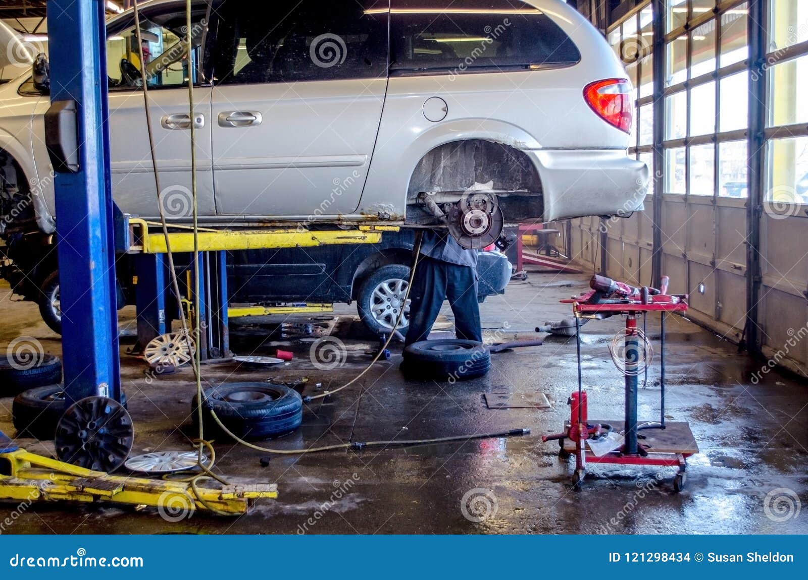 Mechanic Fixing an Auto in a Garage Stock Photo - Image of equipment ...