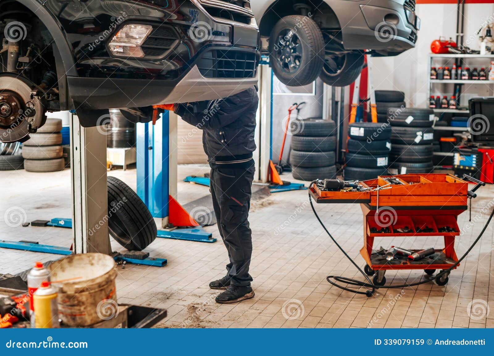 Mechanic Fixing Car Engine on Hydraulic Lift in Garage Workshop Stock ...