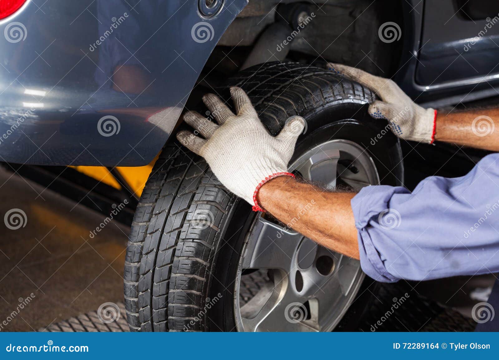 Mechanic Fixing Car Tire stock photo. Image of replacement - 72289164