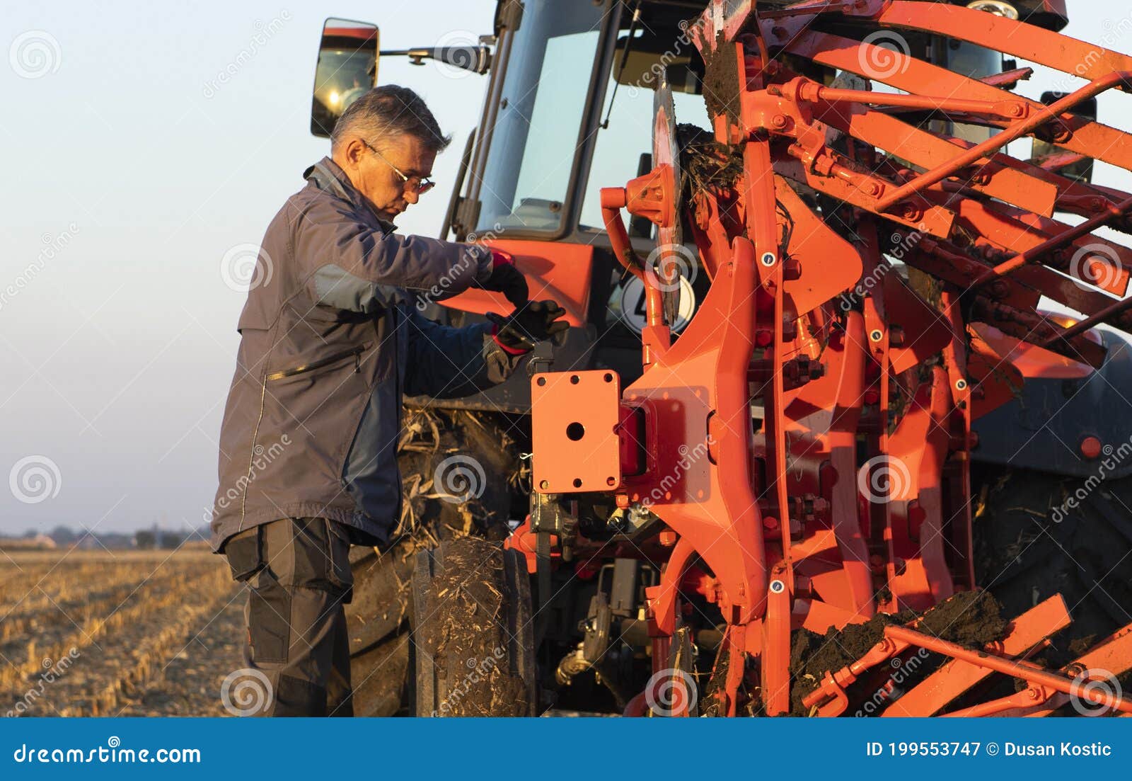 Man Fixing Old Tractor Stock Photo | CartoonDealer.com #28536786