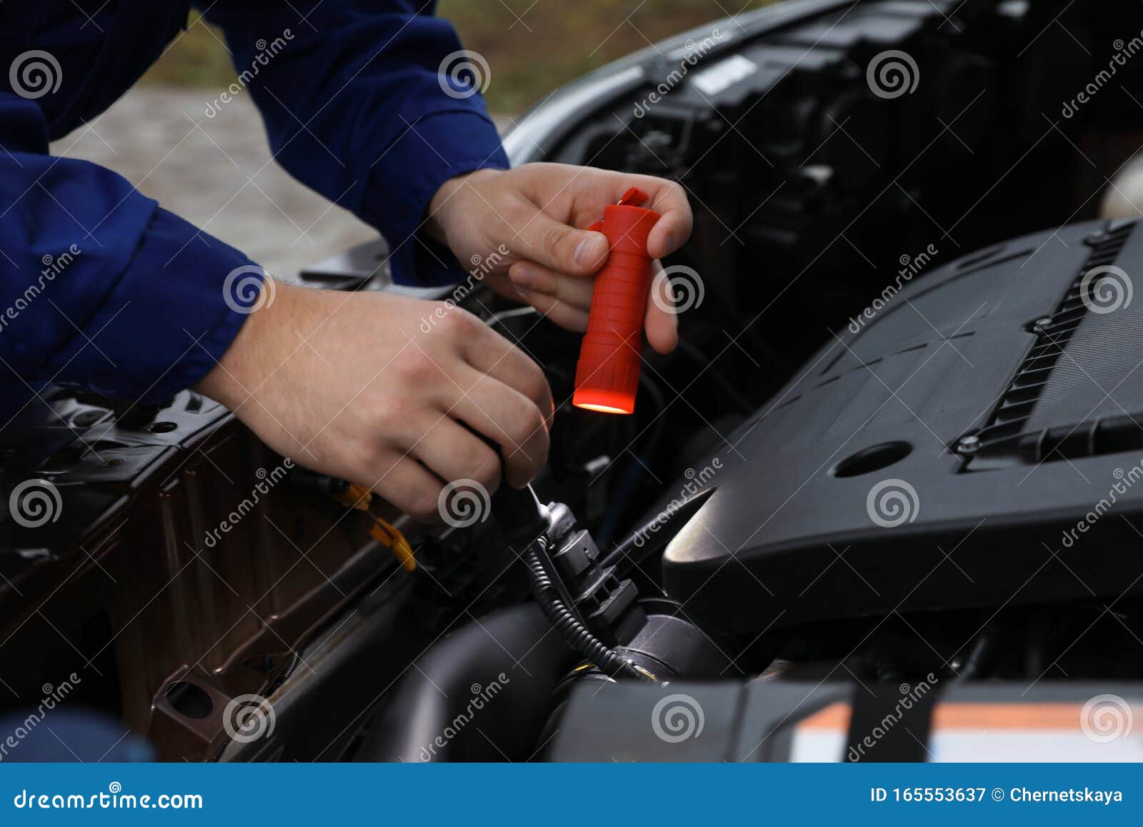 Mechanic with Flashlight Fixing Car, Closeup Stock Image - Image of ...