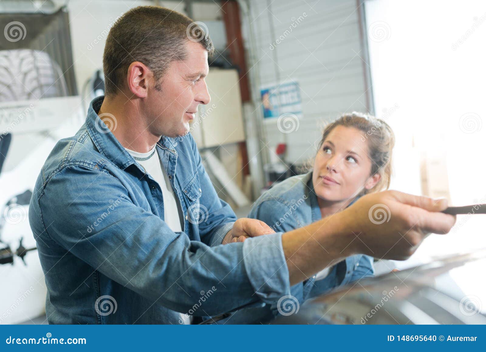 Mechanic Giving Instructions To Female Apprentice Stock Photo - Image ...