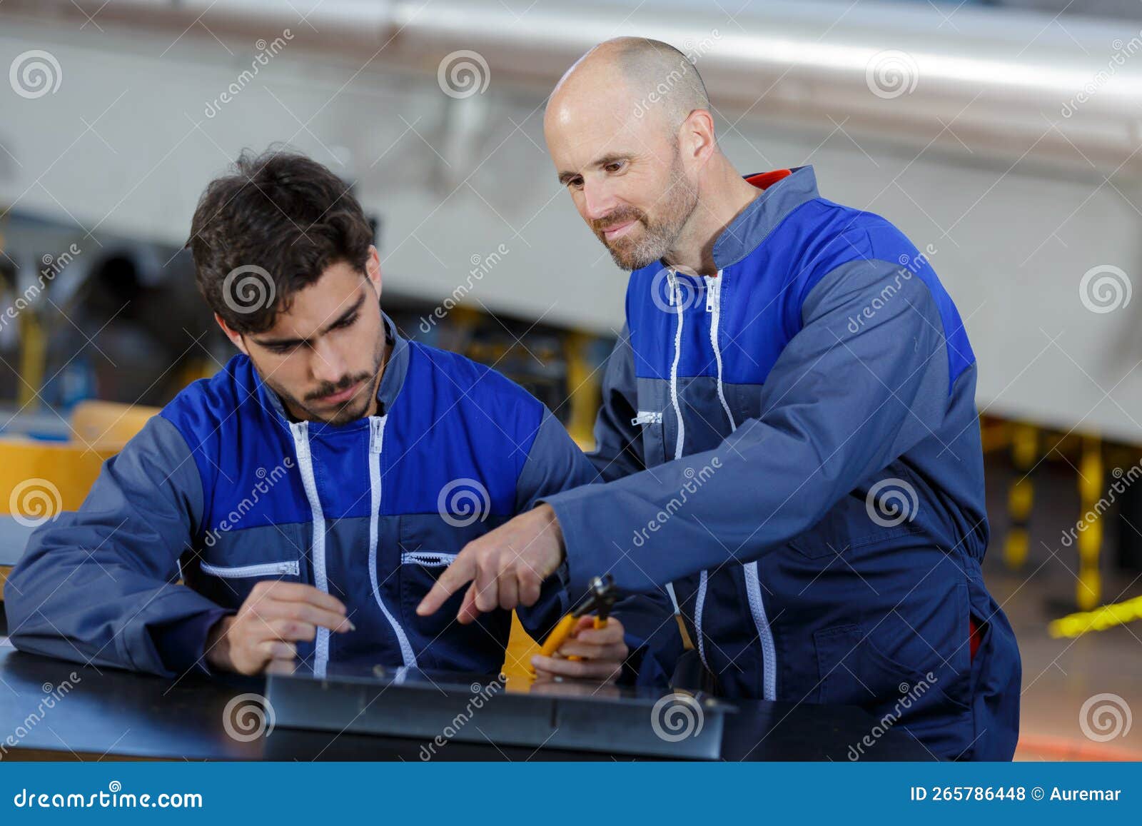 Mechanic Giving Instructions To Apprentice Stock Photo - Image of ...