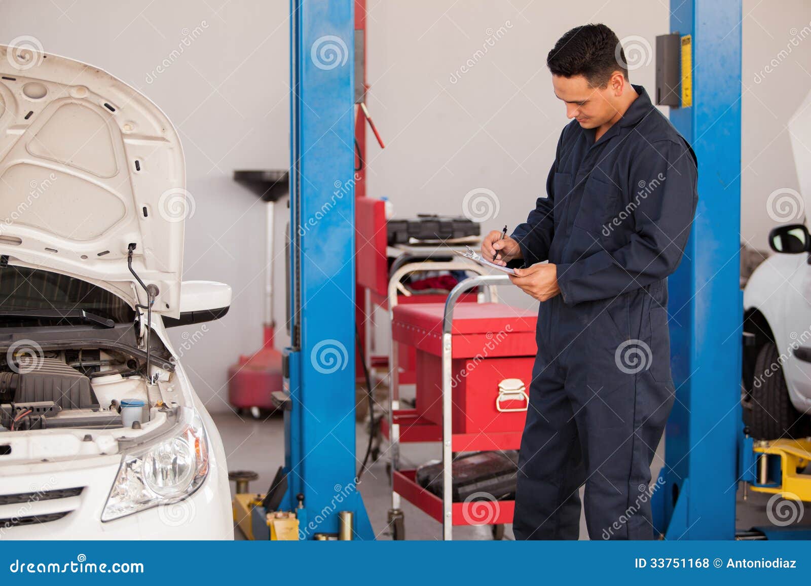 Mechanic Going through a Checklist Stock Photo - Image of toolbox ...