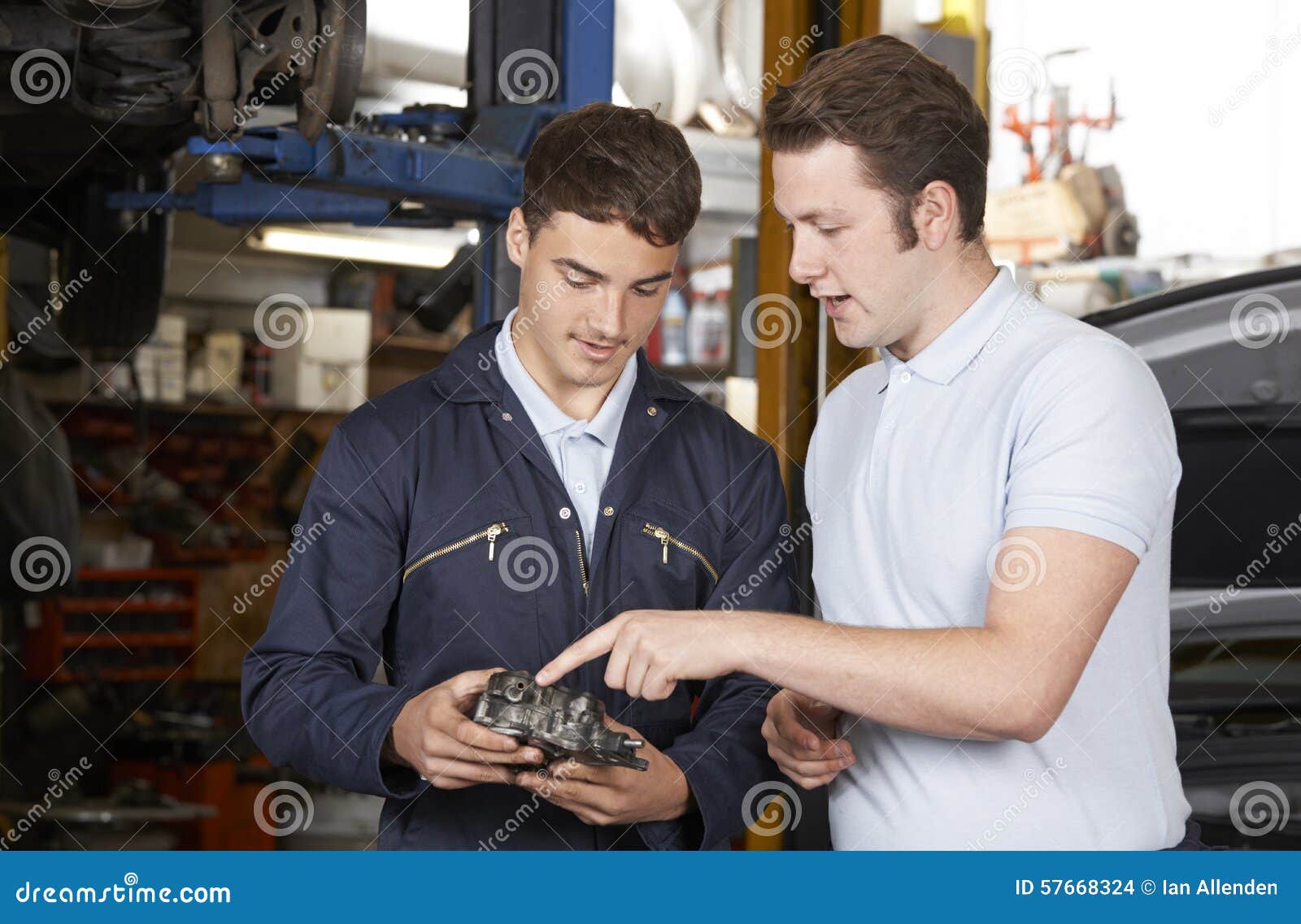 Mechanic Helping Apprentice To Fix Engine Stock Photo - Image of teen ...