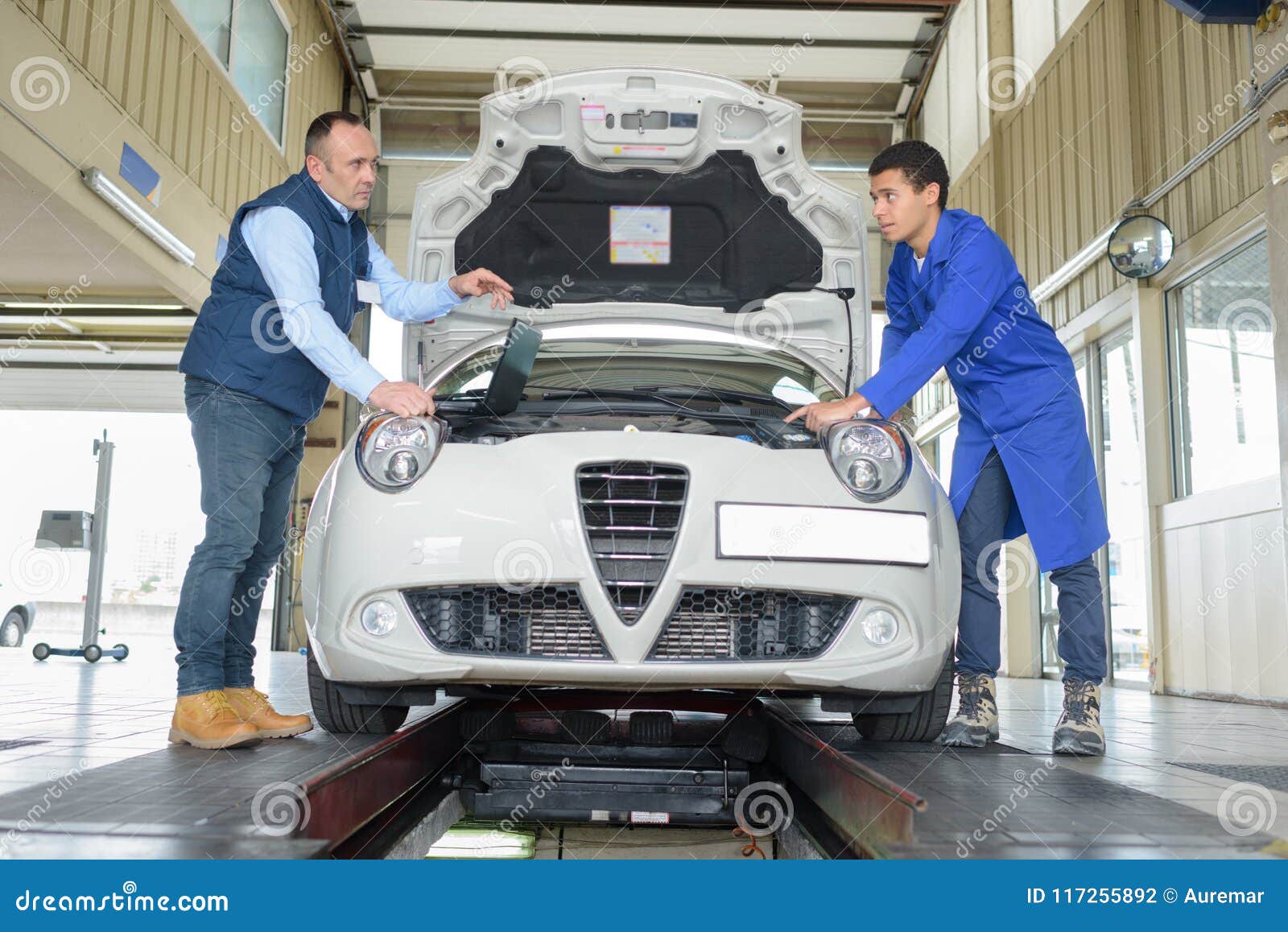 Mechanic Helping Apprentice To Fix Engine Stock Photo - Image of male ...