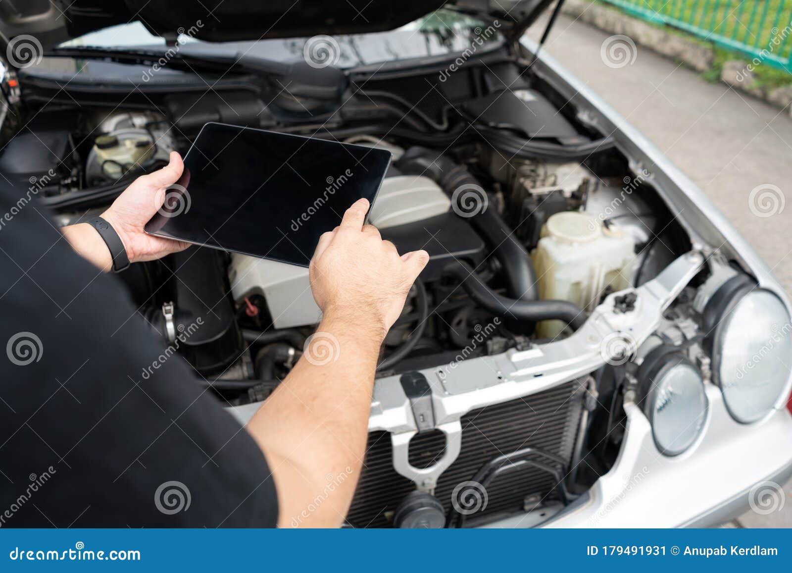 Mechanic Hold Tablet in Hand for Diagnostic or Tune Engine with Smart ...