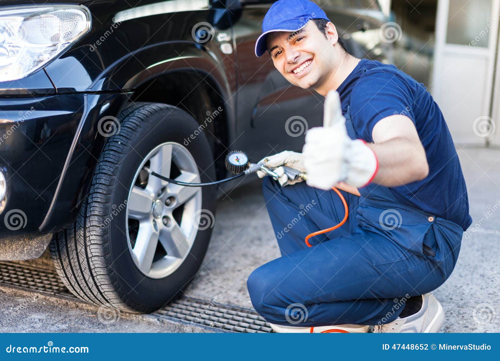 Mechanic inflating a tire stock photo. Image of center - 47448652