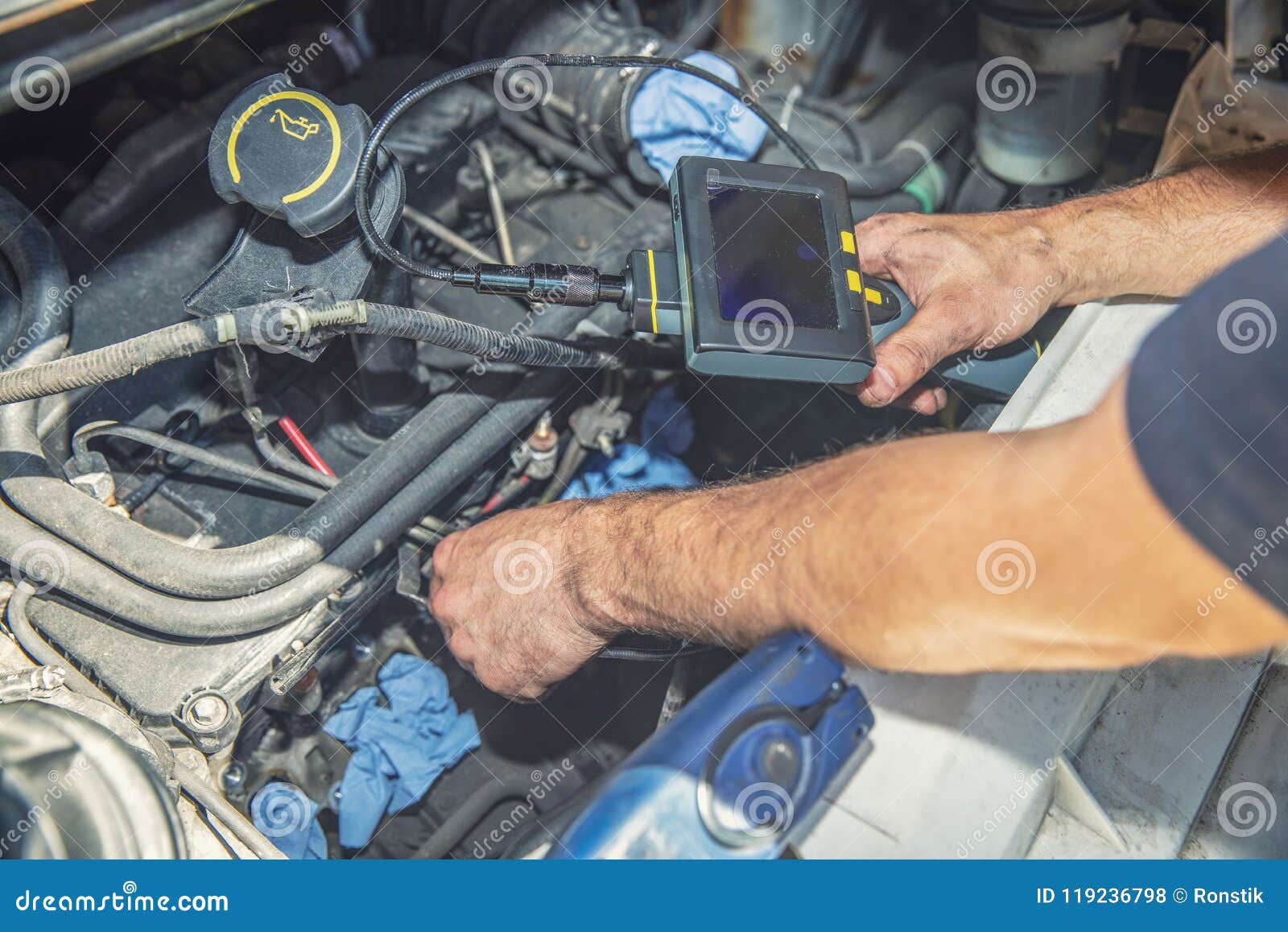Mechanic Inspecting Car Engine with Video Borescope Stock Photo - Image ...