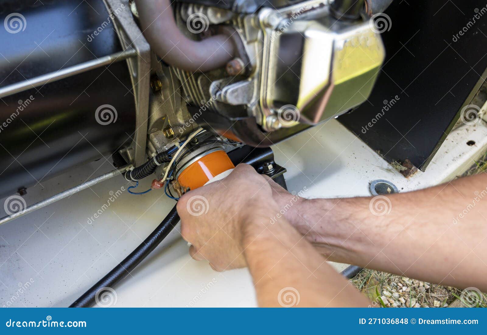 Mechanic Inspecting and Replacing Engine Oil Filter in Stand Up ...