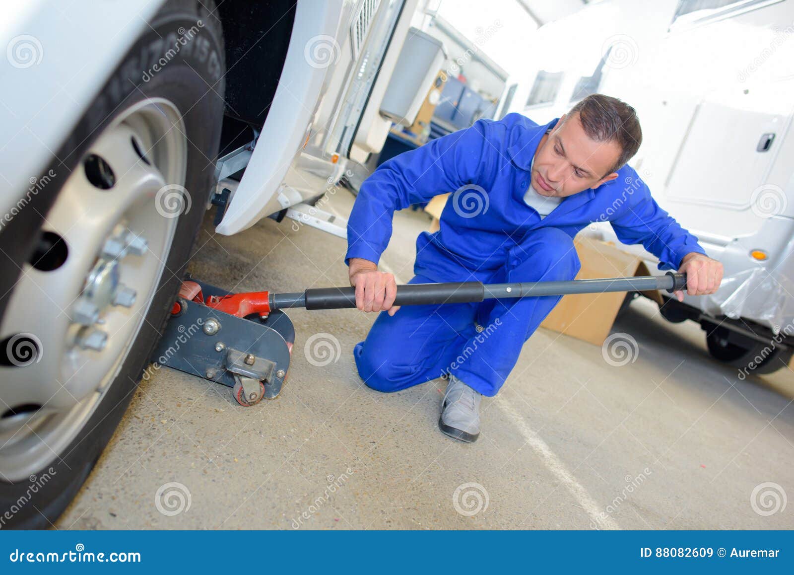 Mechanic Jacking Up Vehicle Royalty-Free Stock Photography ...