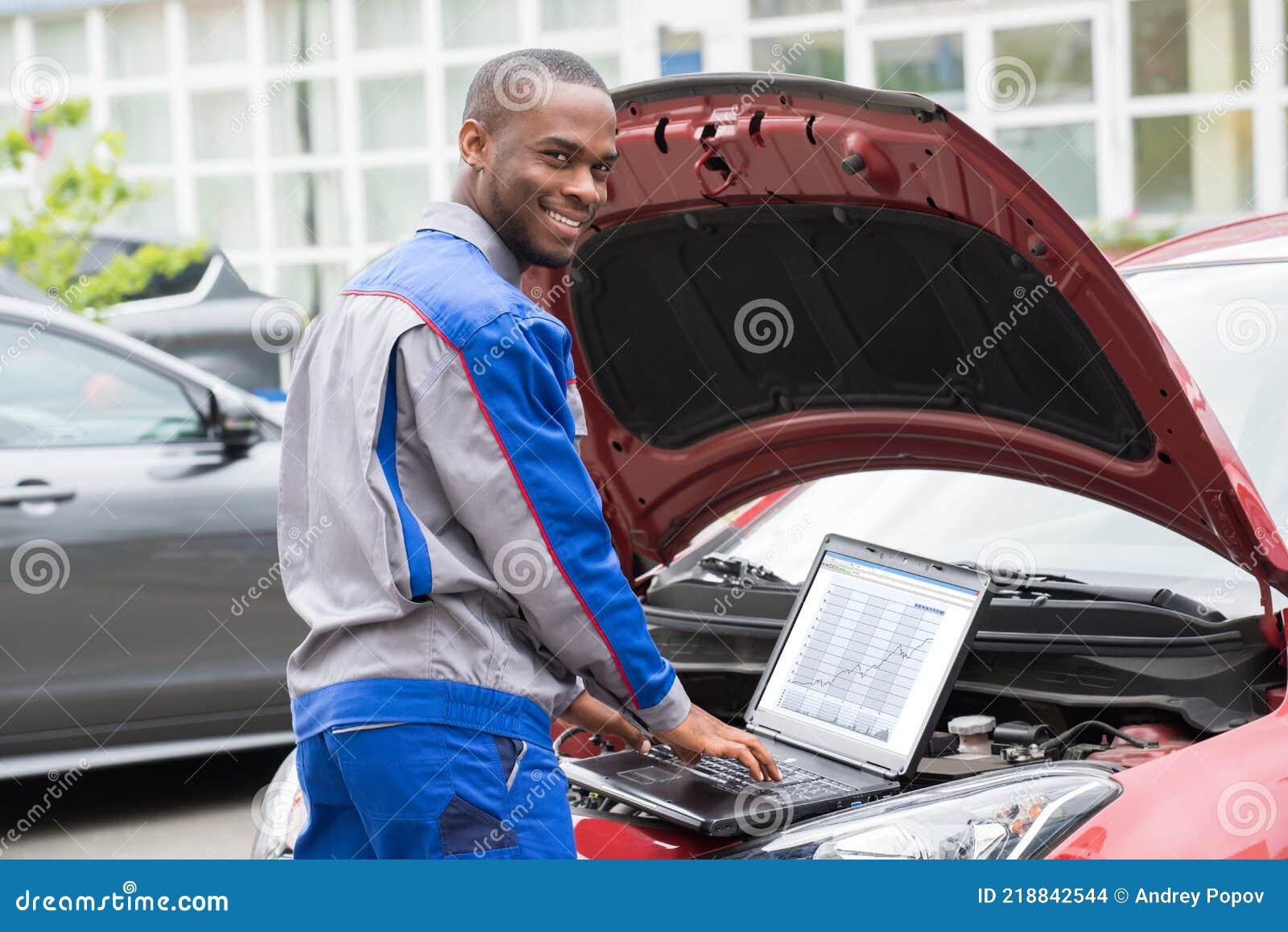 Mechanic with Laptop in Front of Car Engine Stock Photo - Image of ...