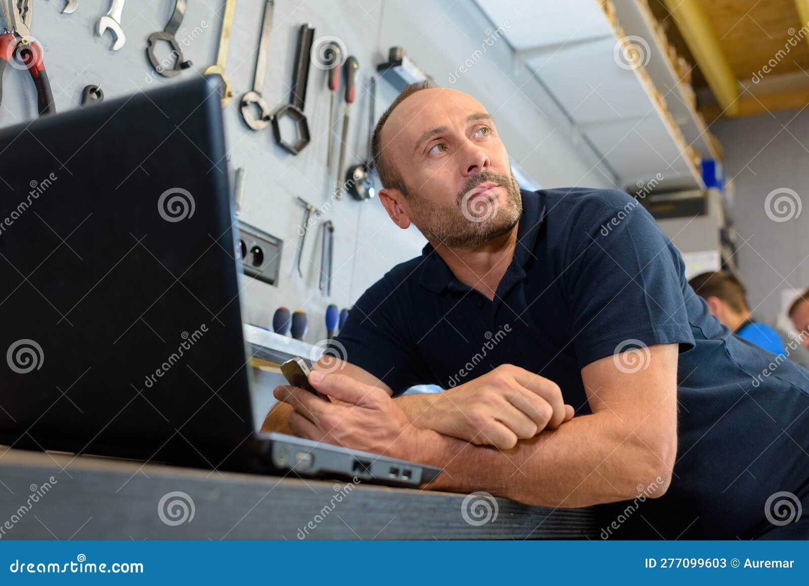 Mechanic with Laptop and Smartphone in Garage Stock Image - Image of ...