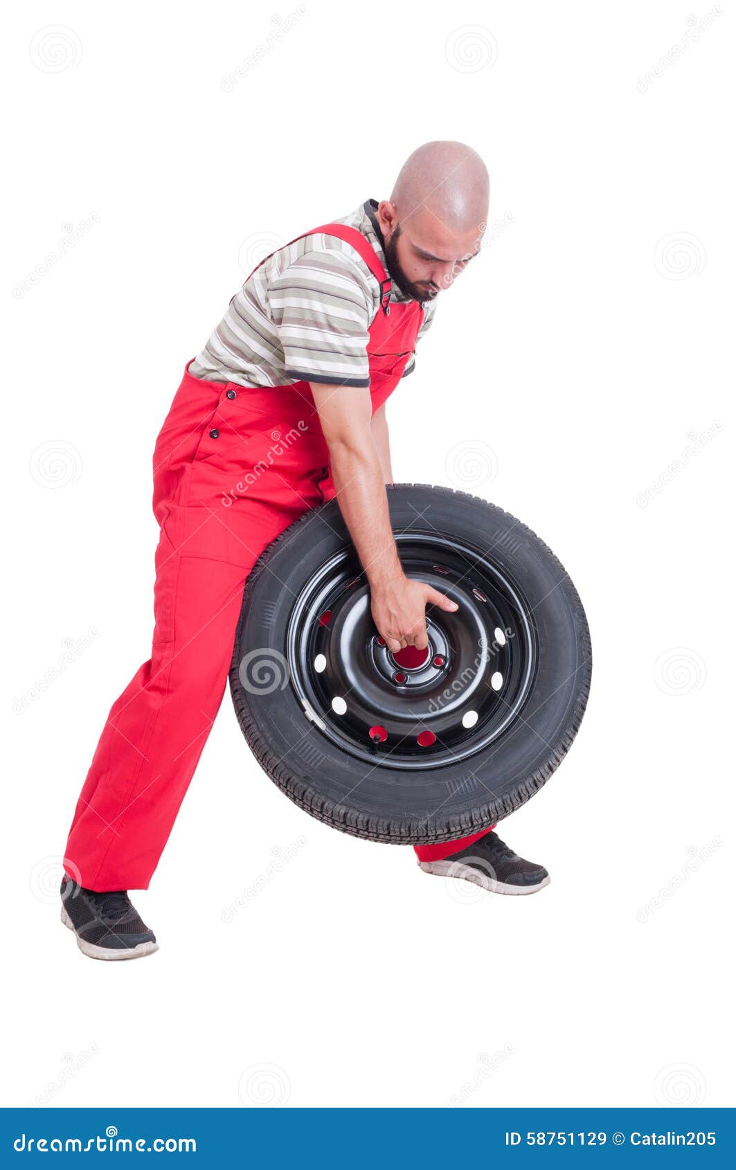 Mechanic Lifting Heavy Car Wheel Stock Image - Image of automobile ...