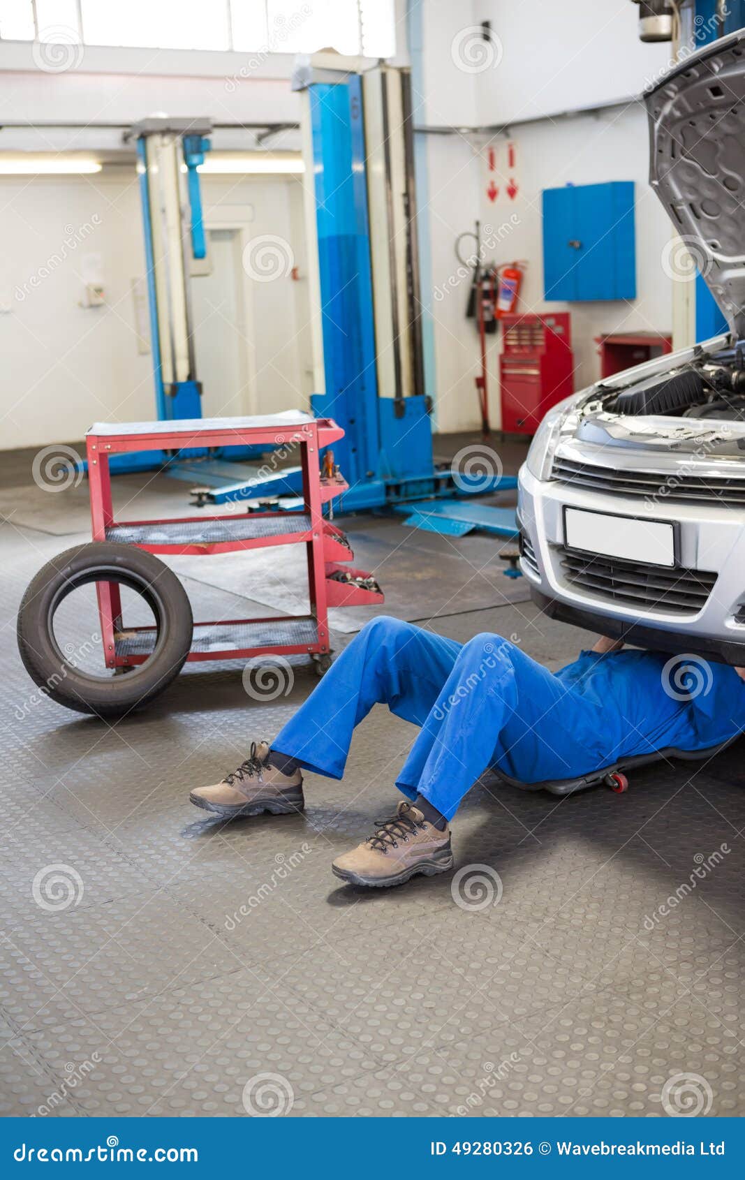Mechanic Lying and Working Under Car Stock Photo - Image of engine ...