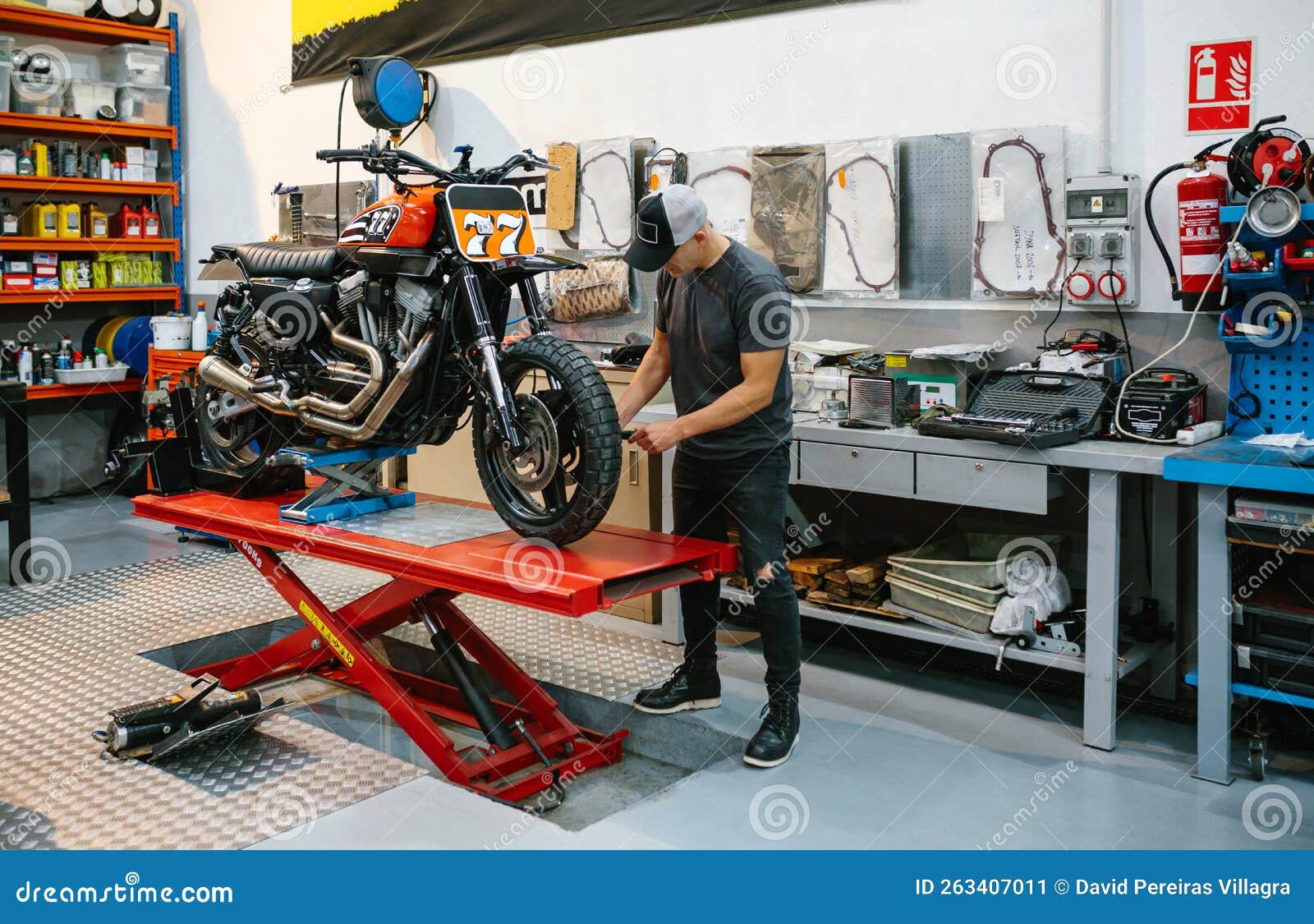 Mechanic Man Checking Custom Motorcycle Over Platform Stock Image ...