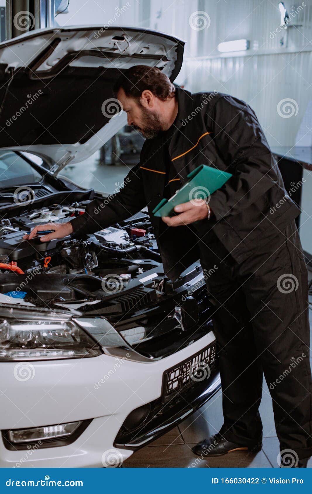 Mechanic Man in a Uniform Write the Problem of the Car in a Map in the ...