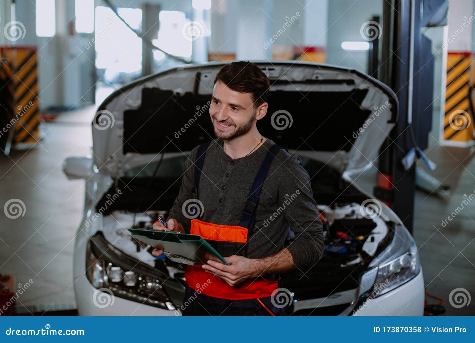 Mechanic Man in a Uniform Write the Problem of the Car in a Map in the ...