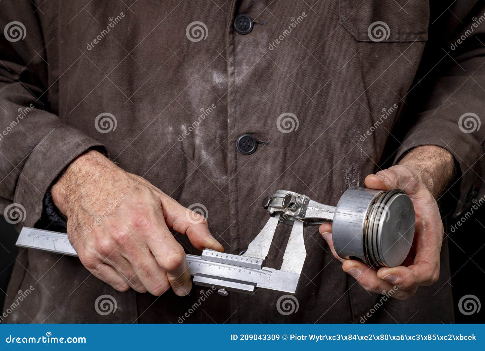 A Mechanic Measuring the Piston of an Internal Combustion Engine. Work ...