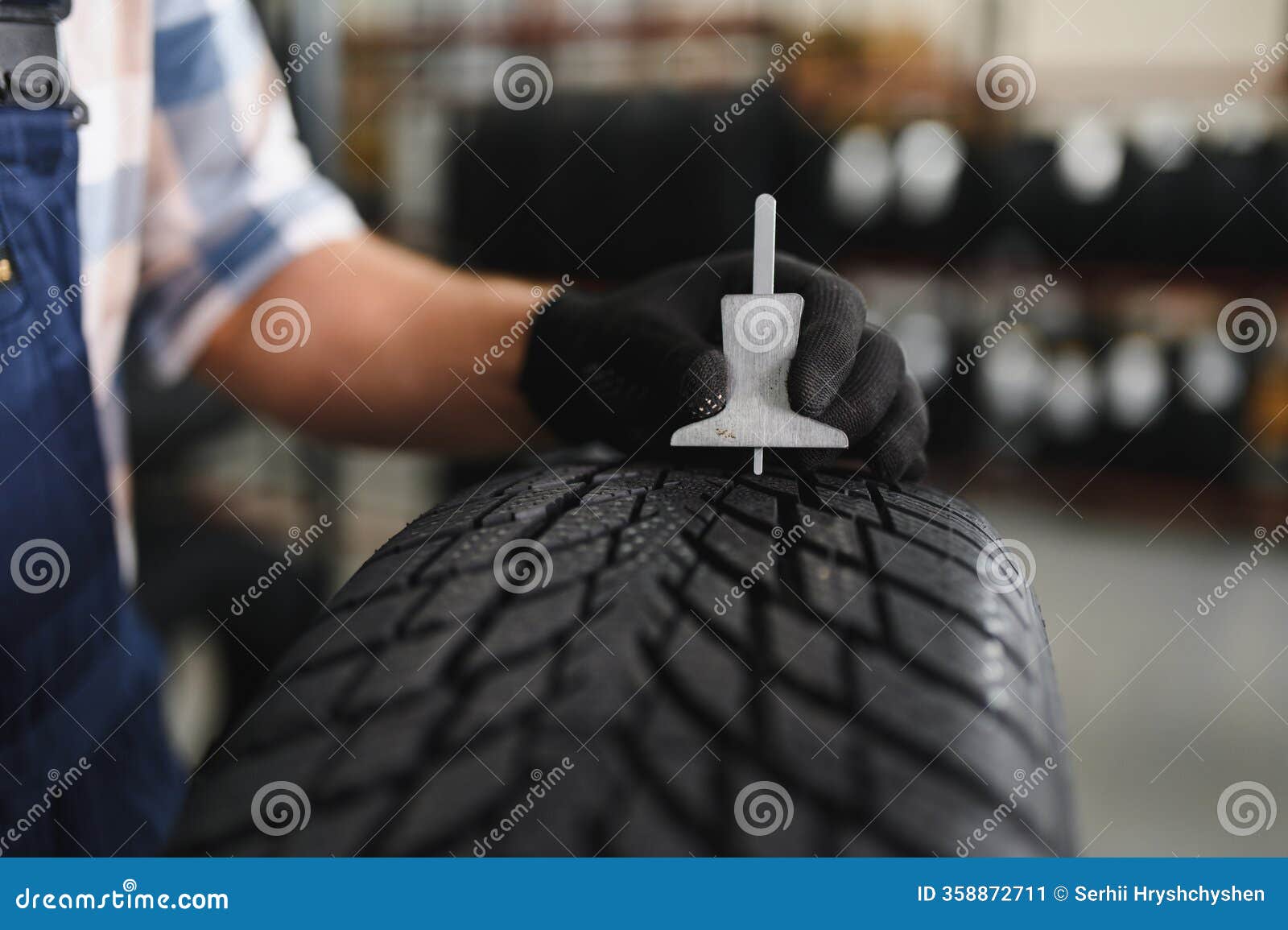 Mechanic Measuring Tire Tread Depth in Automobile Service Centre Stock ...