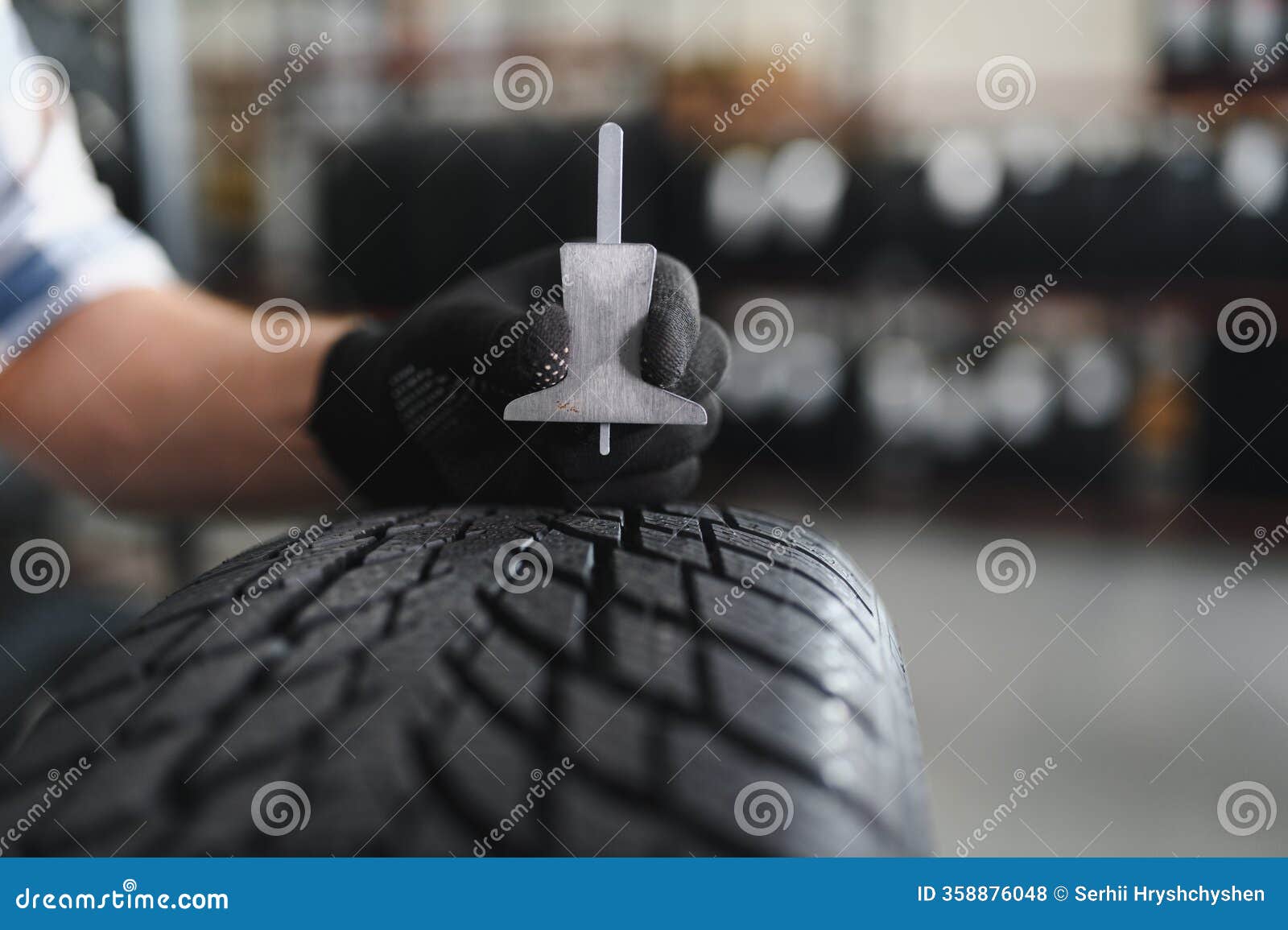 Mechanic Measuring Tire Tread Depth in Automobile Service Centre Stock ...