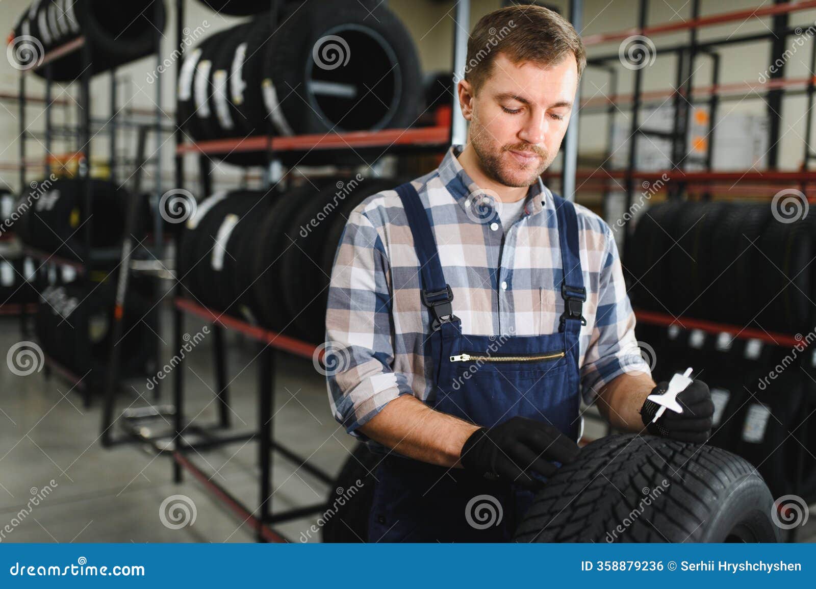 Mechanic Measuring Tire Tread Depth in Automobile Service Centre Stock ...