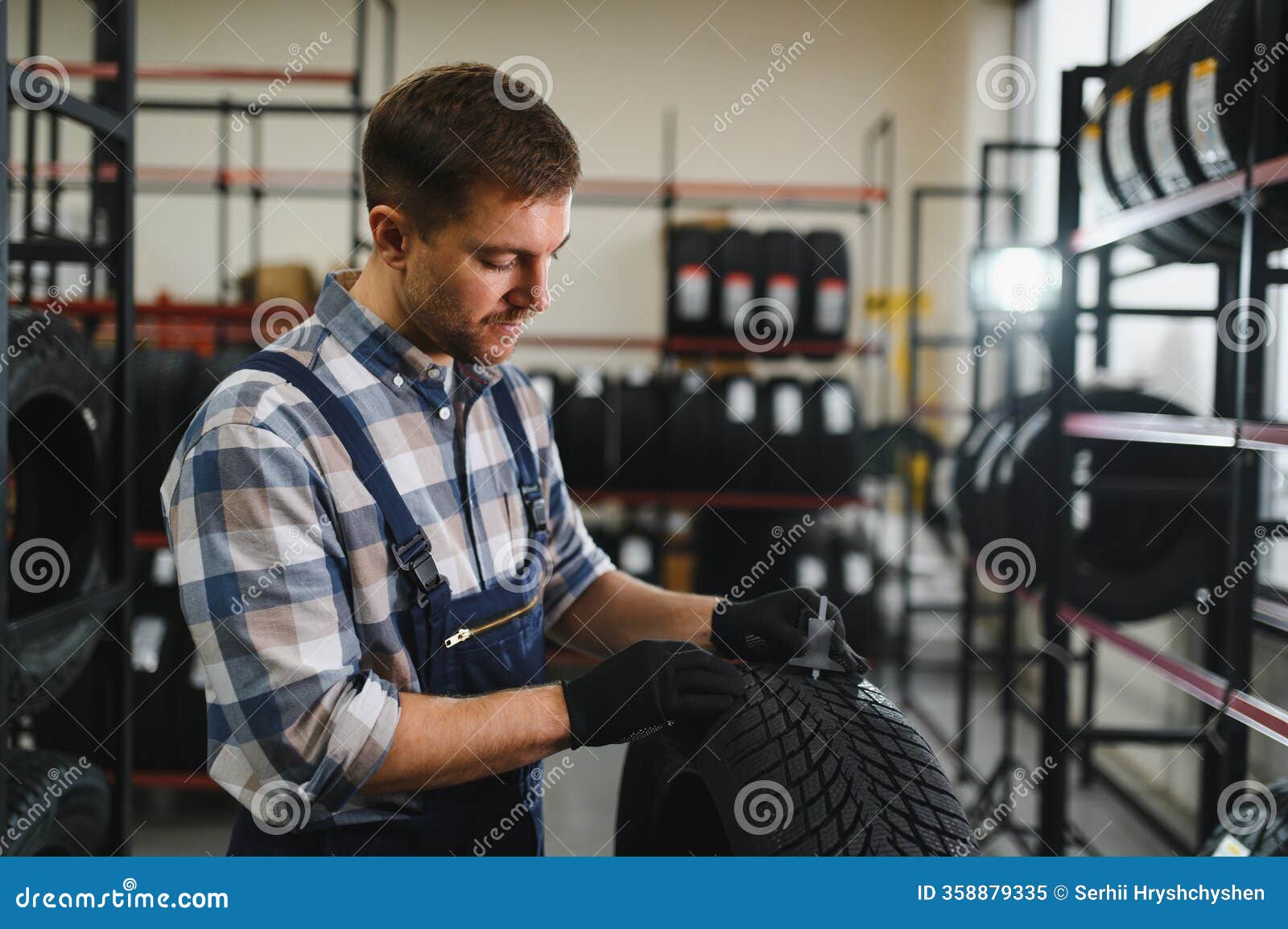 Mechanic Measuring Tire Tread Depth in Automobile Service Centre Stock ...