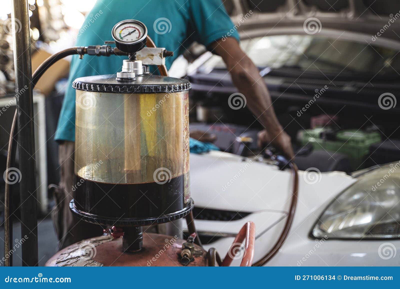 Mechanic Oil Suction from the Engine in the Garage Stock Photo - Image ...