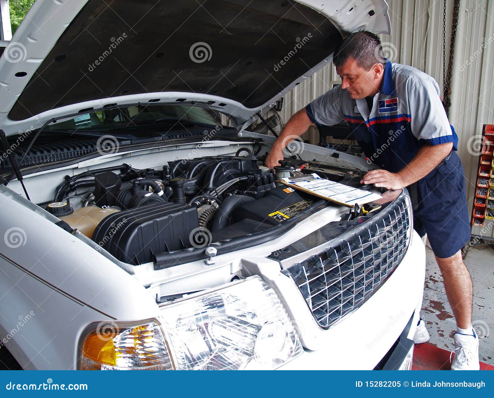 Mechanic Performing a Routine Service Inspection Stock Image - Image of ...