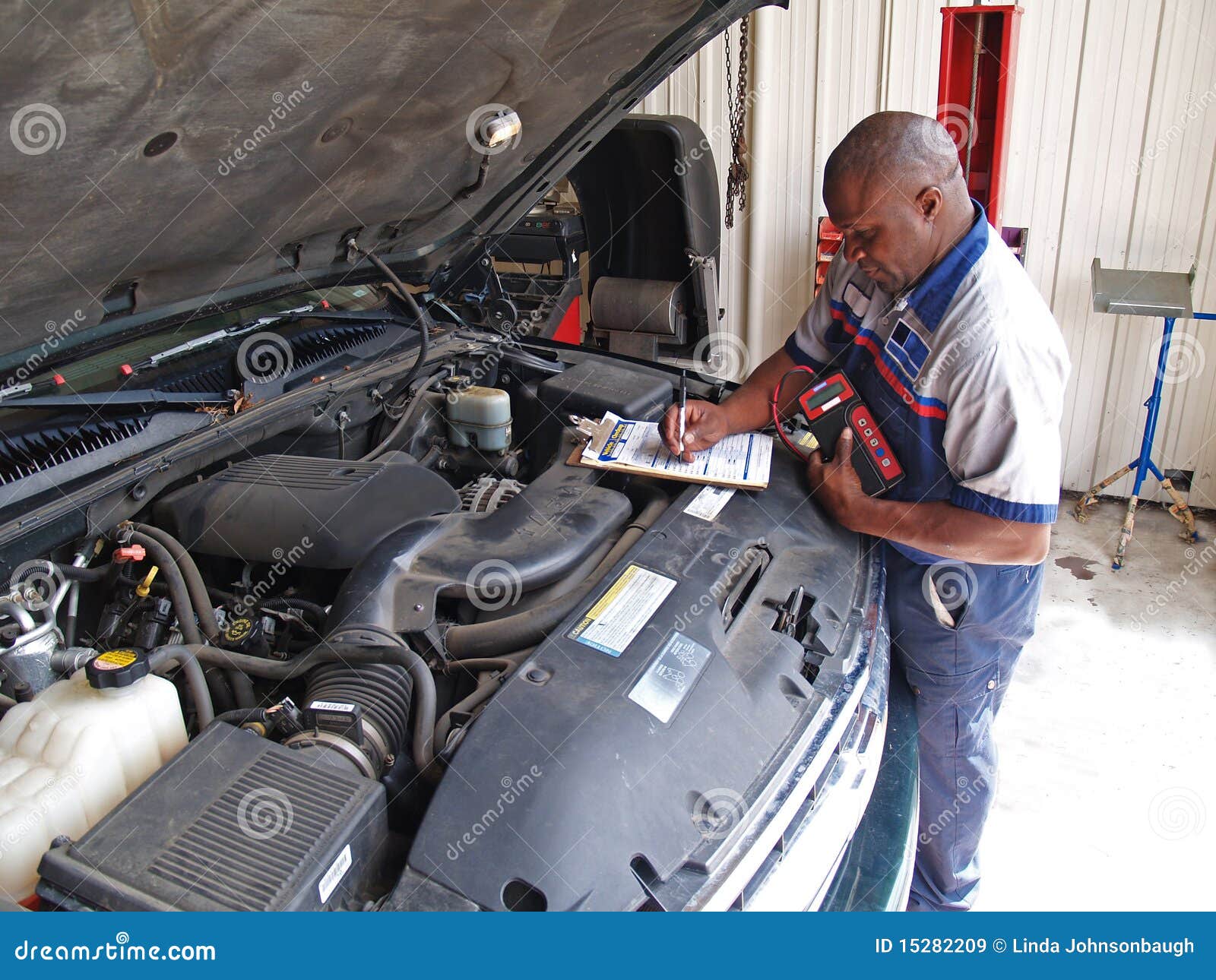 Mechanic Performing a Routine Service Inspection Stock Image - Image of ...