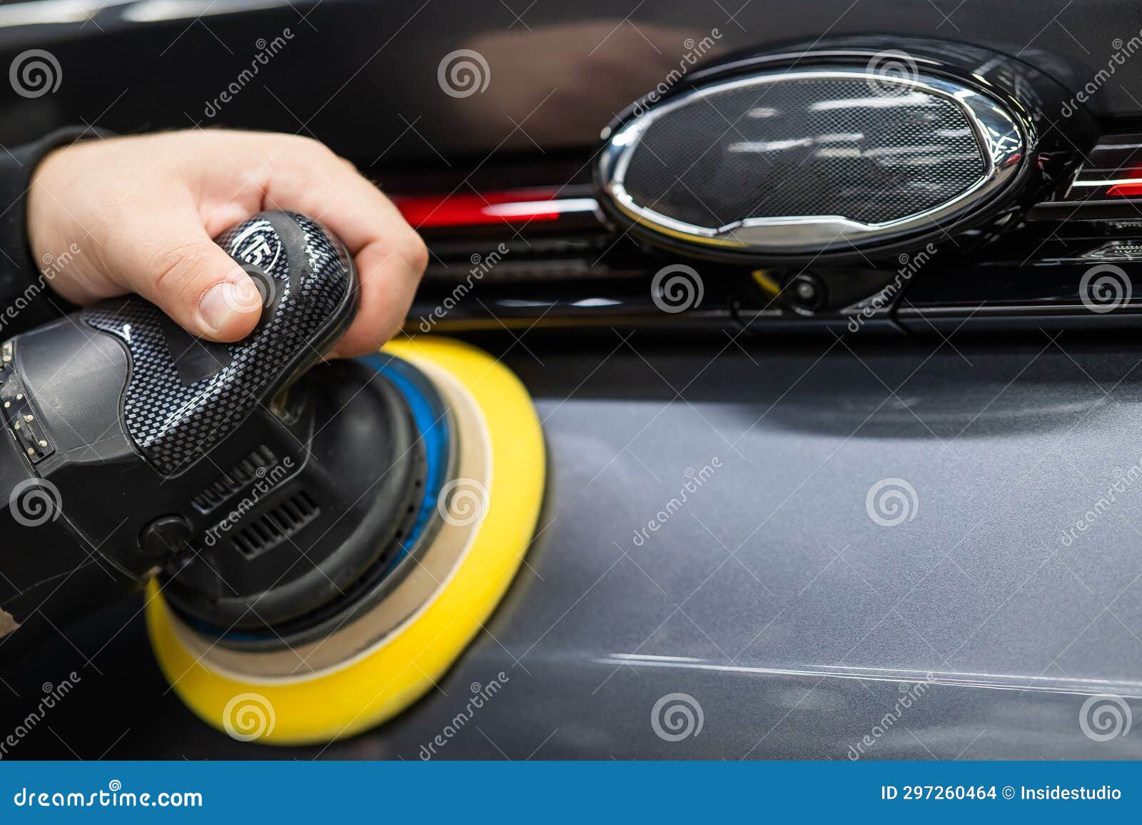 A Mechanic Polishes the Surface of a Car Trunk Door with a Grinding ...