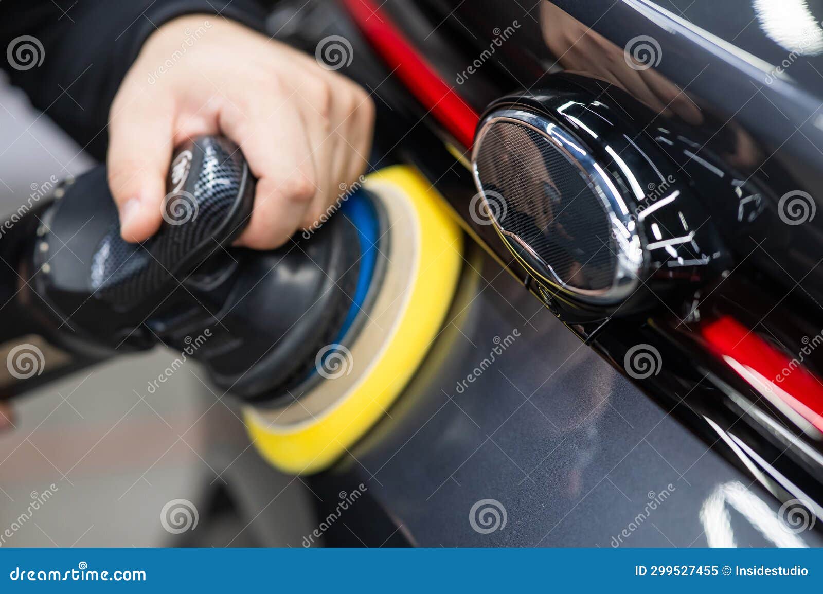 A Mechanic Polishes the Surface of a Car Trunk Door with a Grinding ...