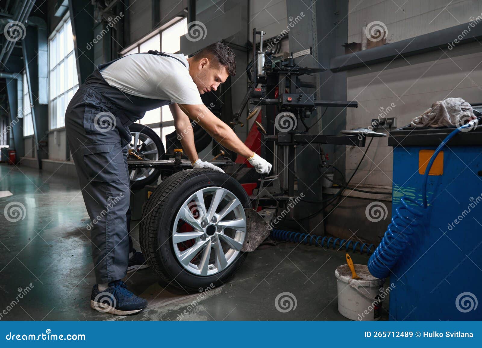 Professional Worker Checking Technical Condition of Car Wheel Stock ...