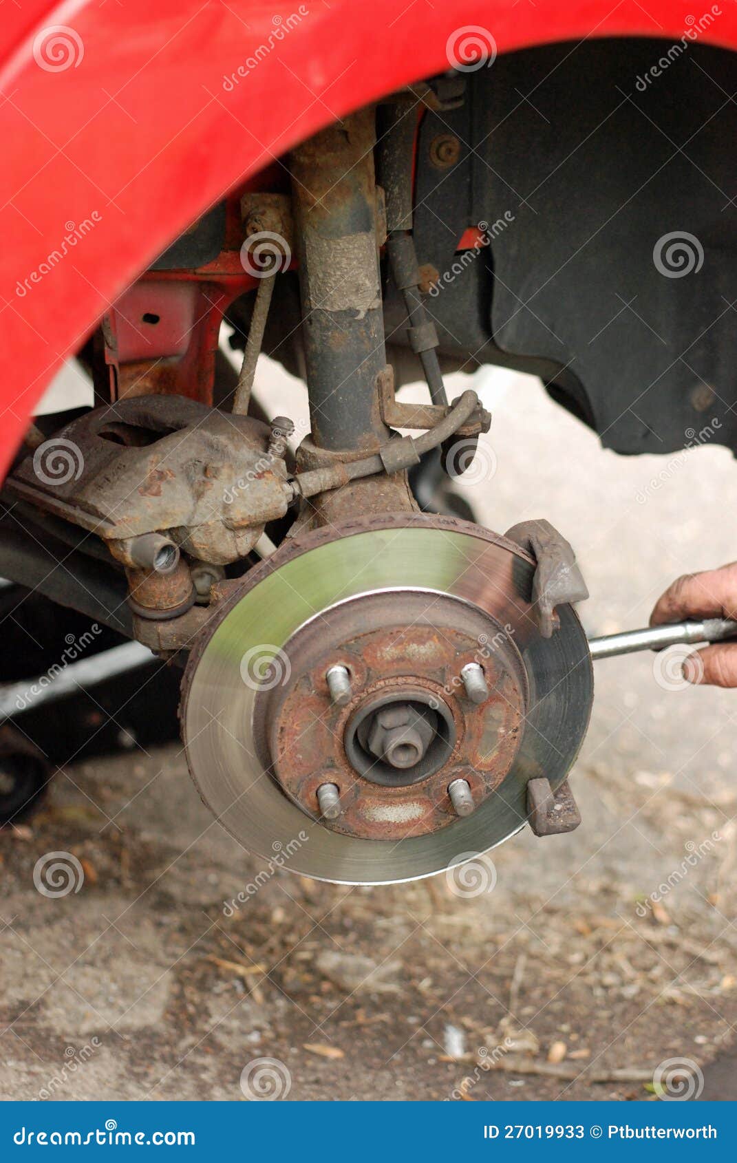 Mechanic Removing Brake Pads From Old Disc Brake. Picture Image: 27019933