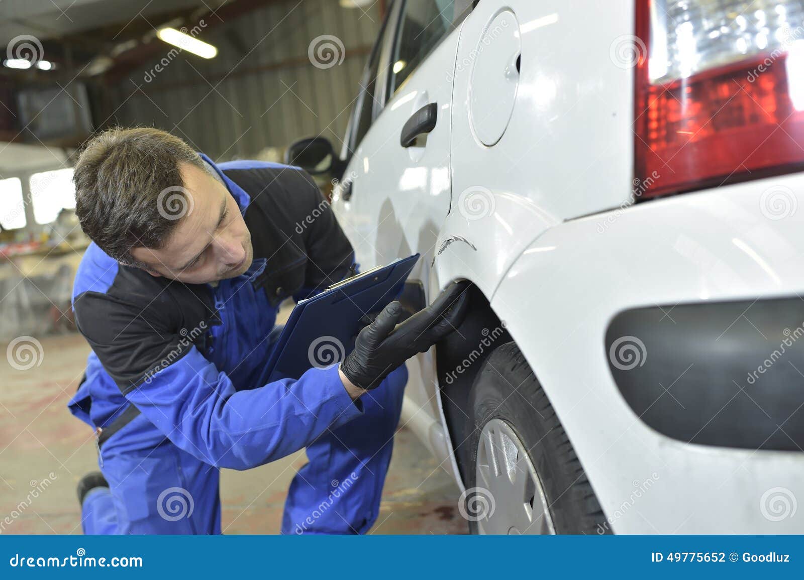 Mechanic repairing car stock photo. Image of examining - 49775652