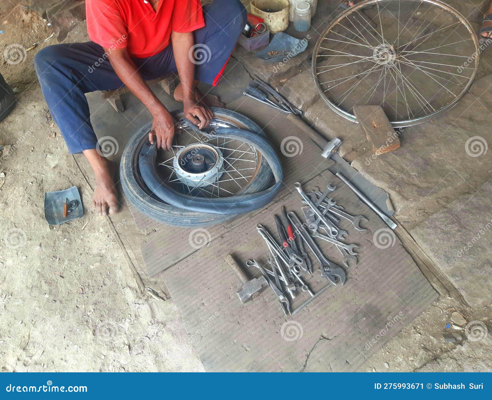 A Mechanic Repairing the Punctured Tyre Using His Tools Stock Image ...