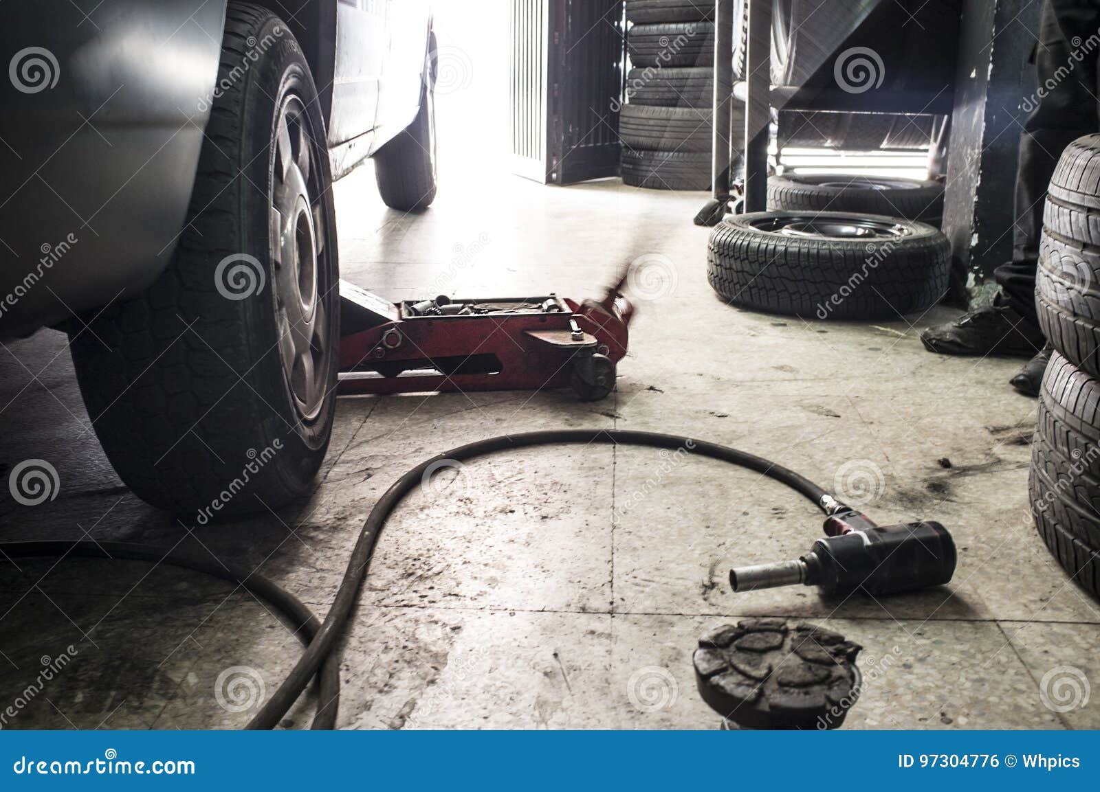 Mechanic Rising a Van. he is Using a Jack for Tire Change Stock Photo ...