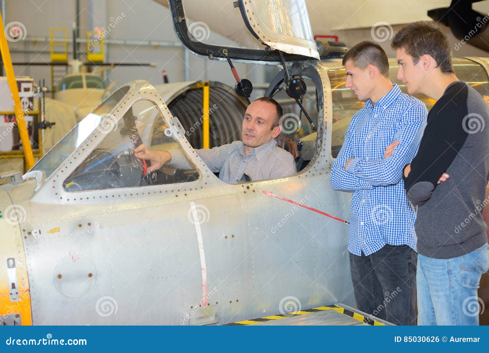 Mechanic Showing Young Men Inside Cockpit Stock Photo - Image of ...