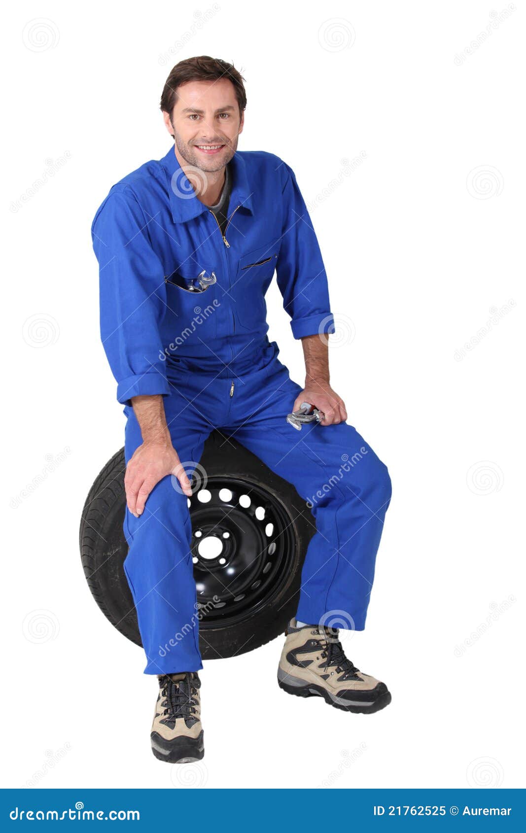 Mechanic sitting on a tyre stock image. Image of spanner - 21762525