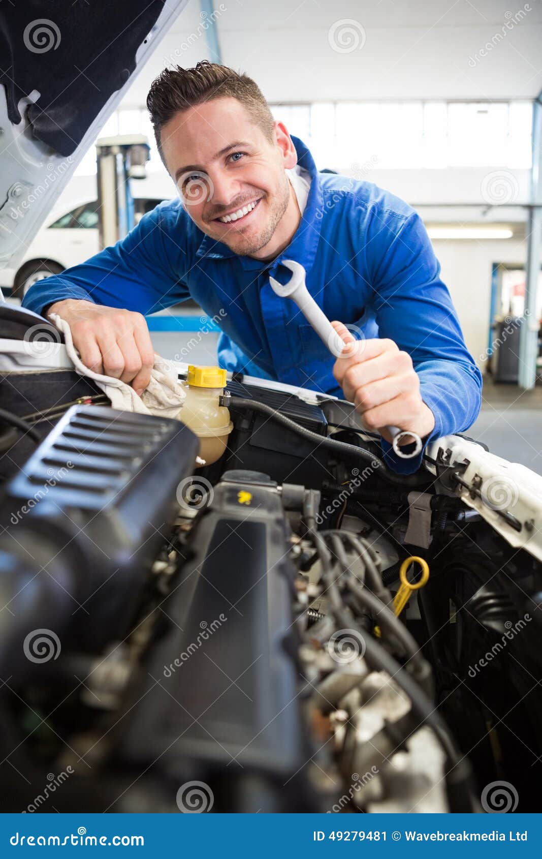Mechanic Smiling at the Camera Fixing Engine Stock Image - Image of ...